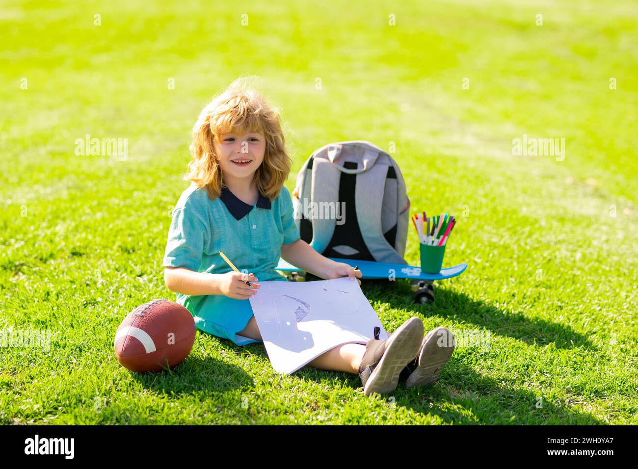 Child painter draw on playground. School boy in park outdoor doing ...