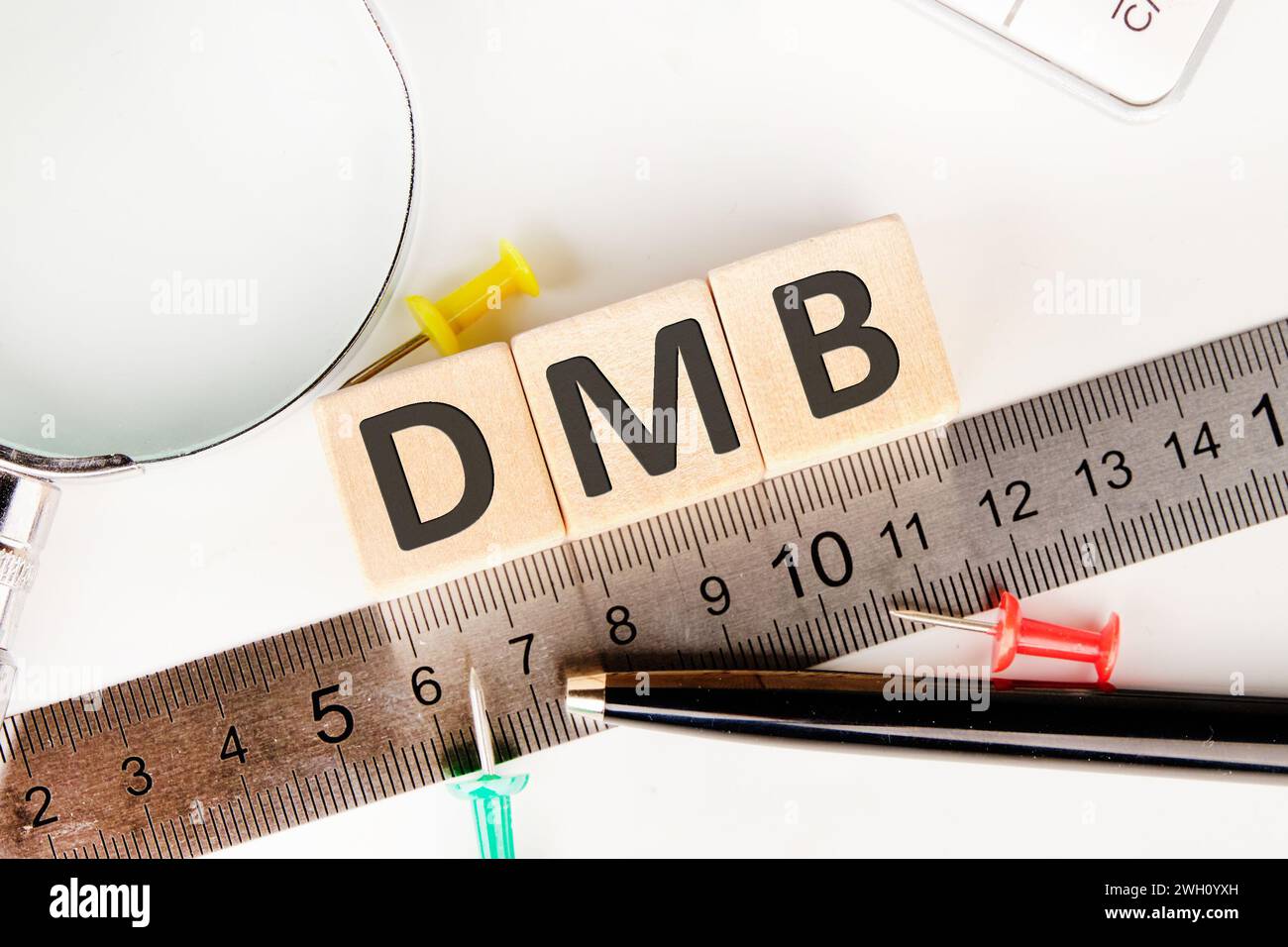 DMB text of non-wooden cubes next to a calculator, pen, measuring ruler ...