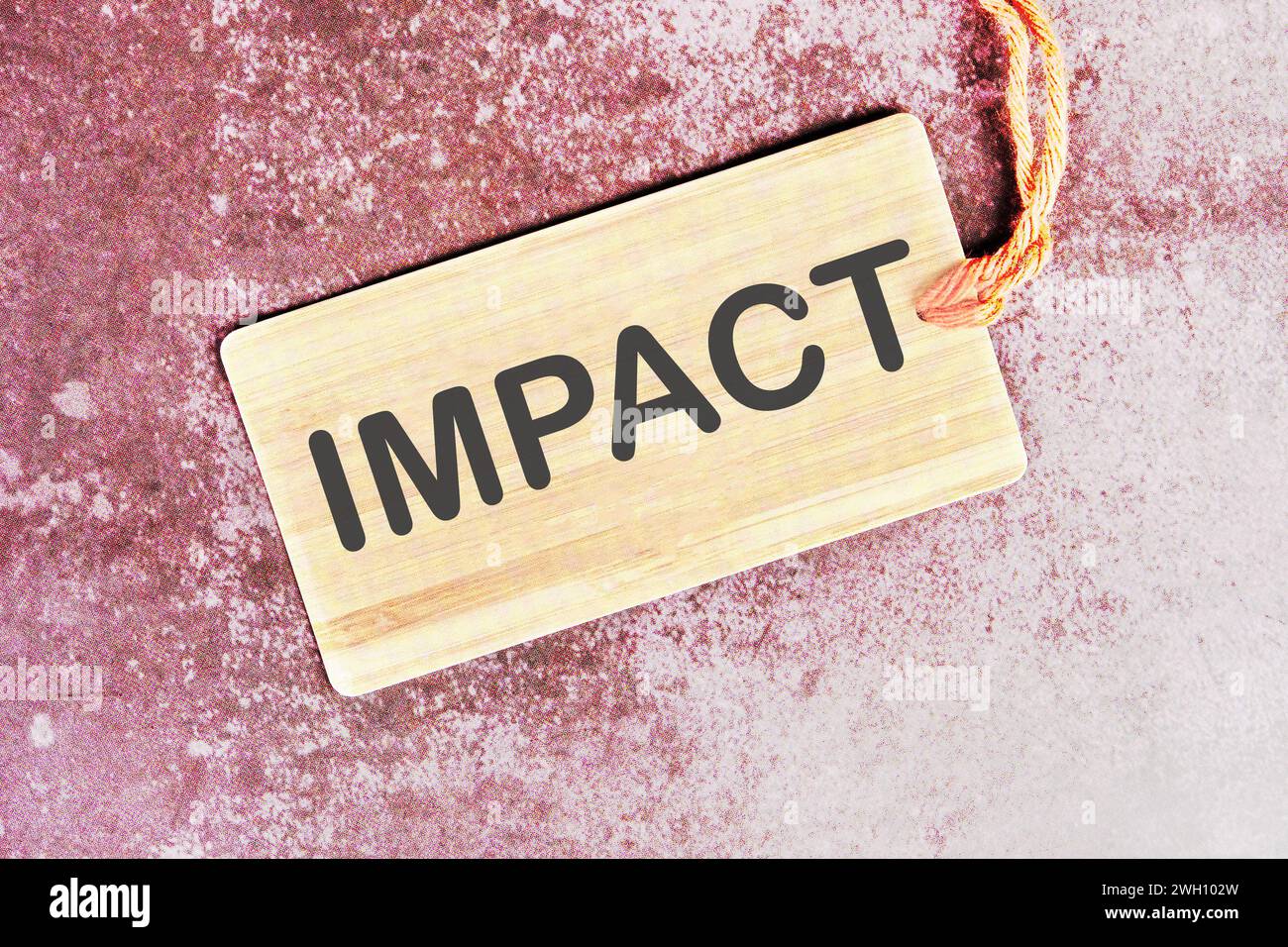 IMPACT word written on a card with a rope on an abstract background ...