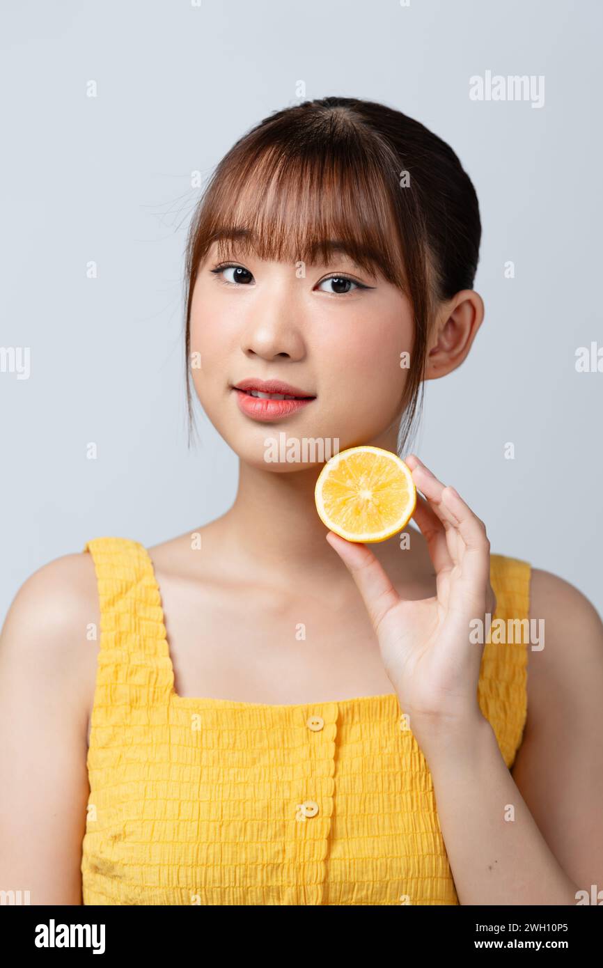 Beautiful young woman with cut lemon on white background Stock Photo ...