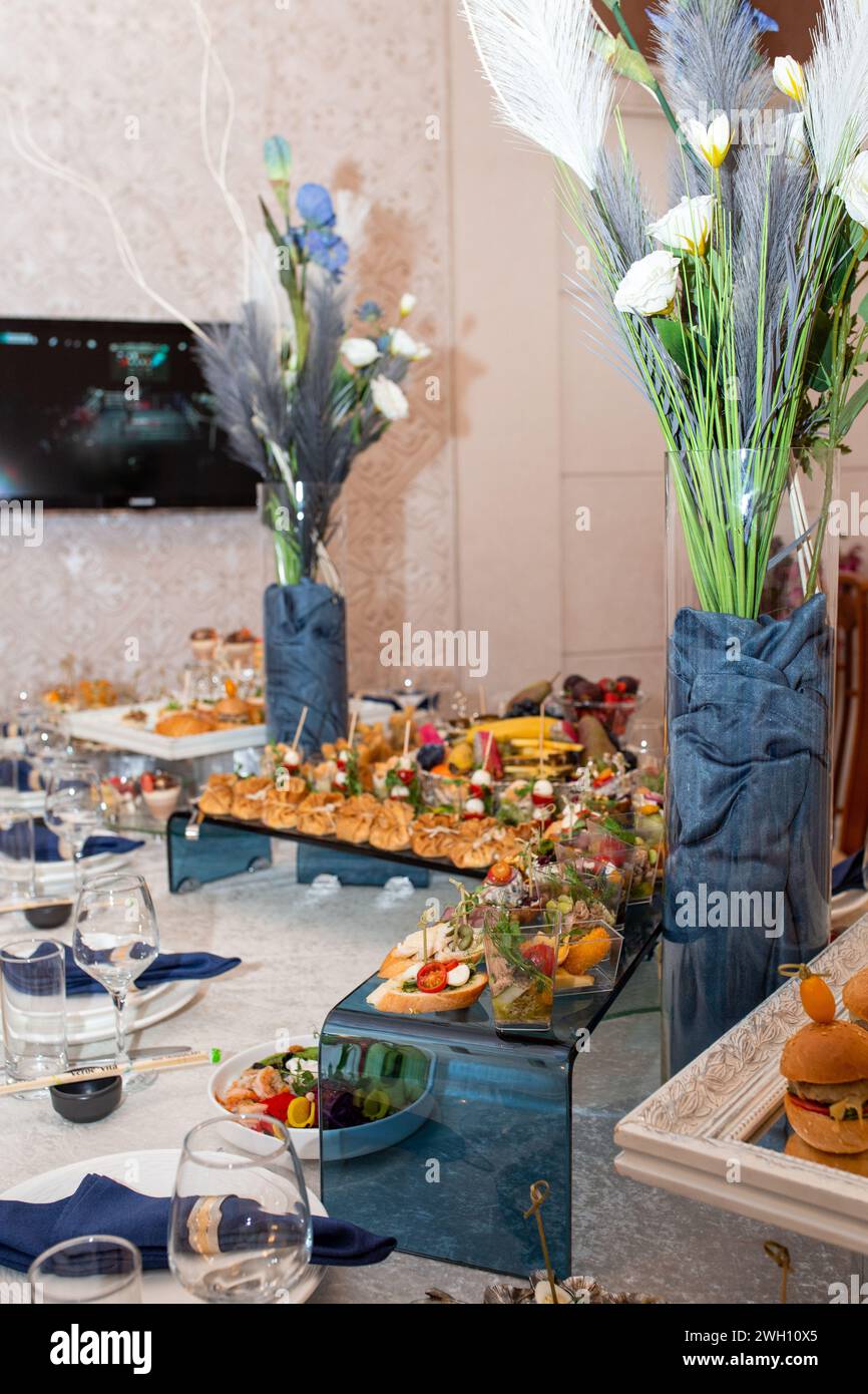 An elegant buffet table with a variety of delicious food, adorned with ...