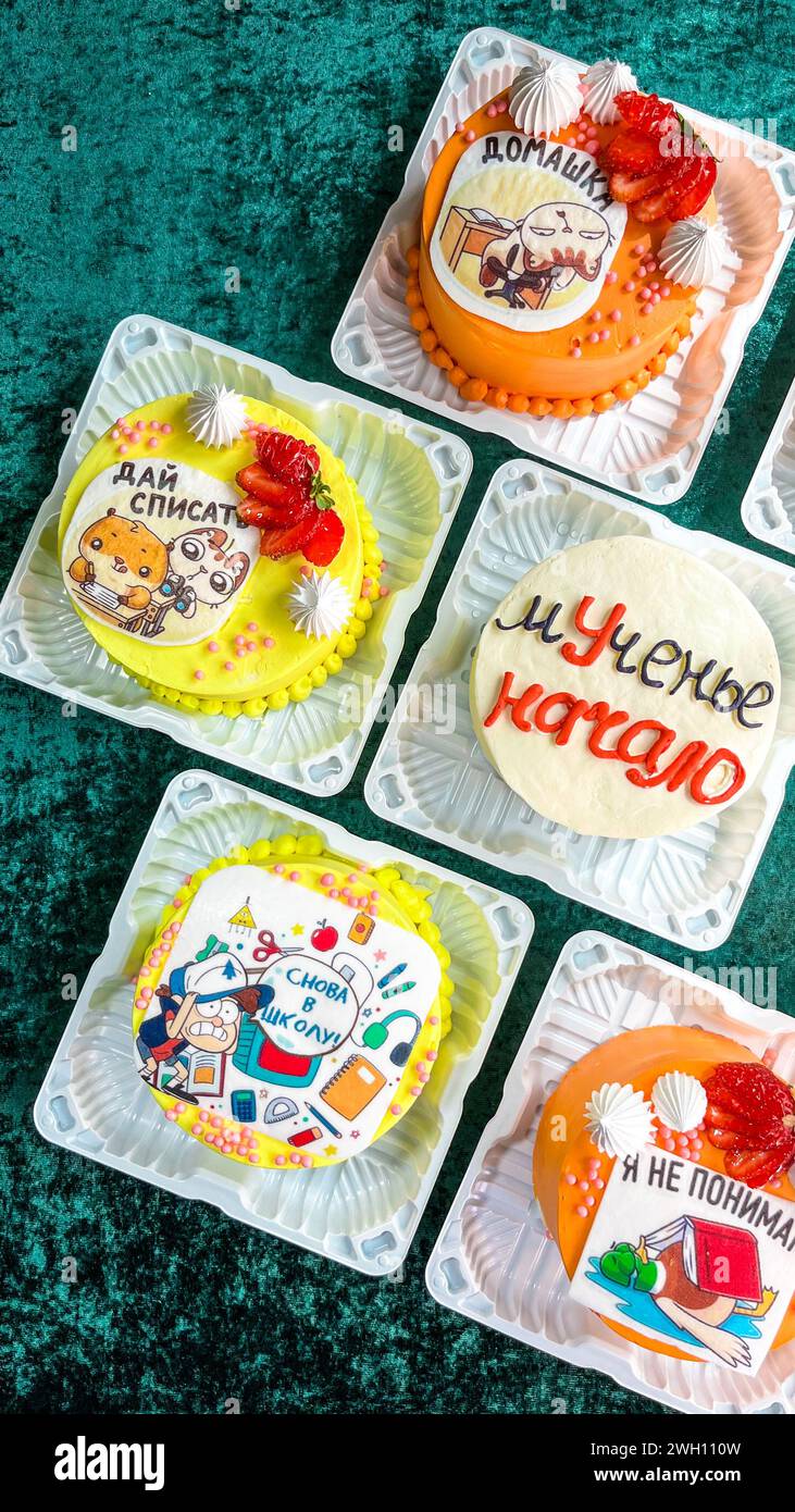 An assortment of six small square cakes with unique icing designs and ...
