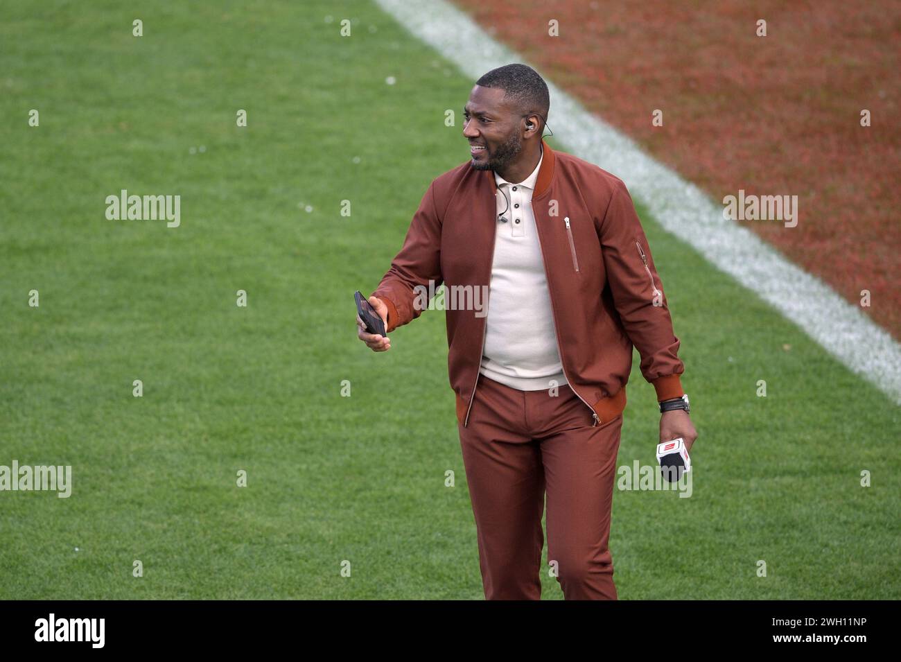 ESPN's Ryan Clark works from the field during the flag football event ...