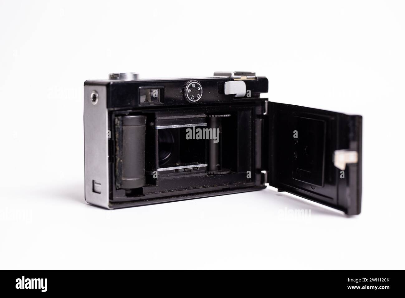 The back of a black and silver retro camera is open, exposing the film ...