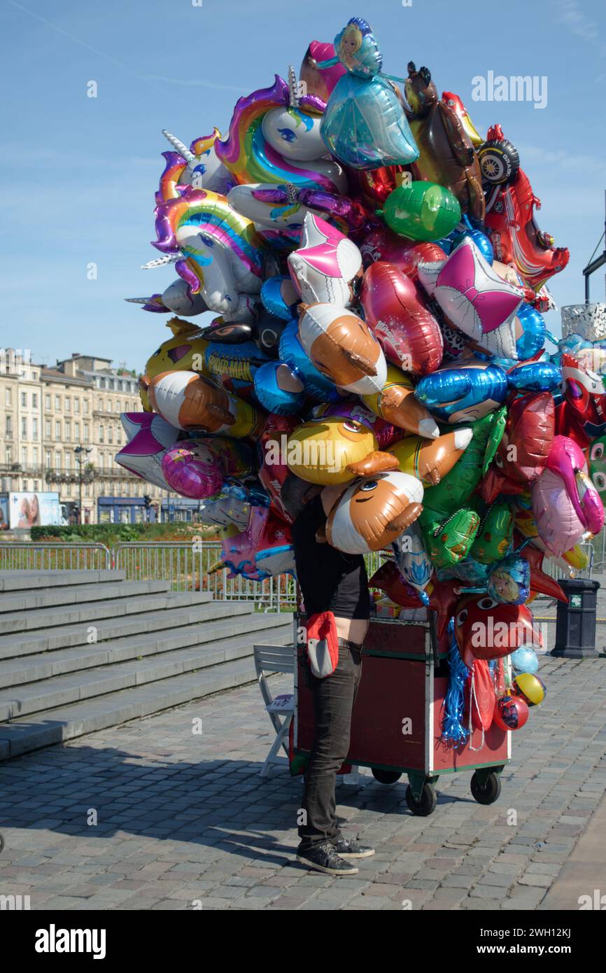 Children's balloon seller. Colorful balloons. Seller in the city center ...