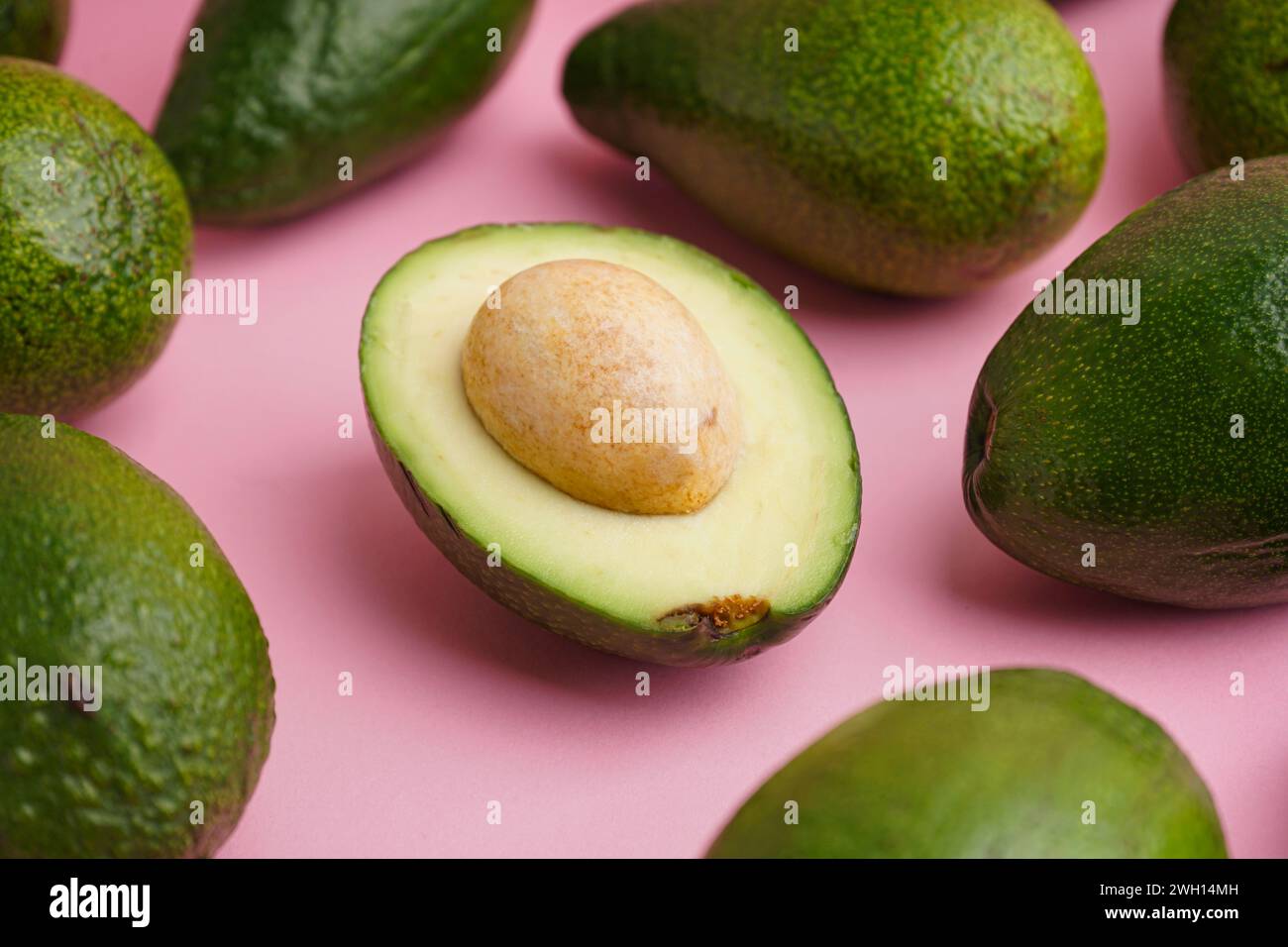 Fresh ripe avocados on pink background Stock Photo - Alamy