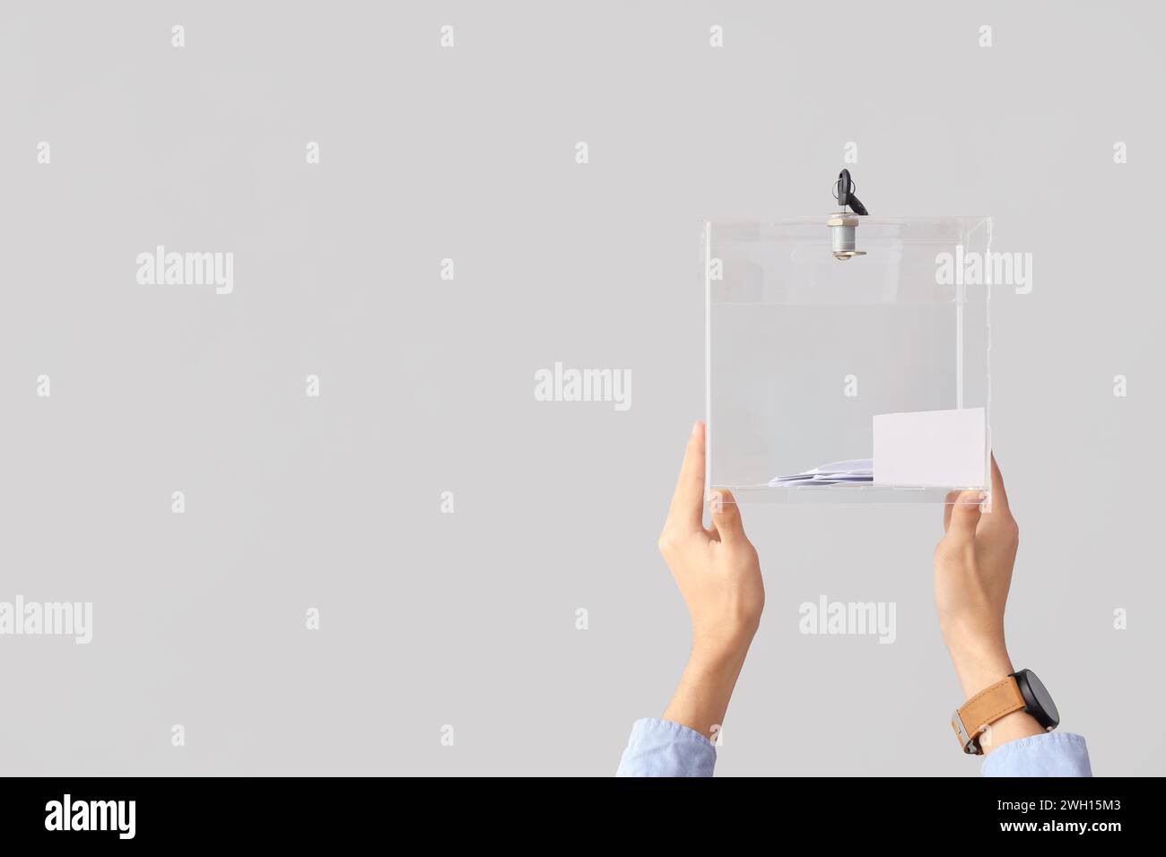 Hands holding ballot box on white background. Election concept Stock ...