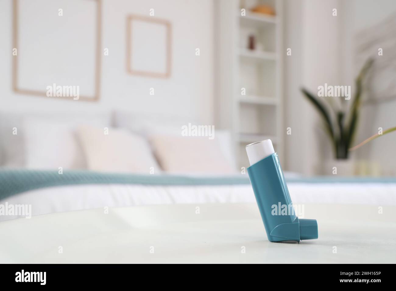 Asthma inhaler on table in bedroom, closeup Stock Photo - Alamy