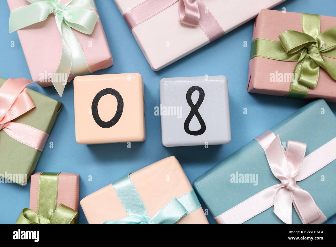 Cube calendar with date 08 and gift boxes on blue background ...