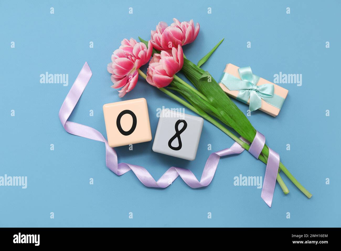 Cube calendar with date 08, beautiful tulips and gift box on blue ...