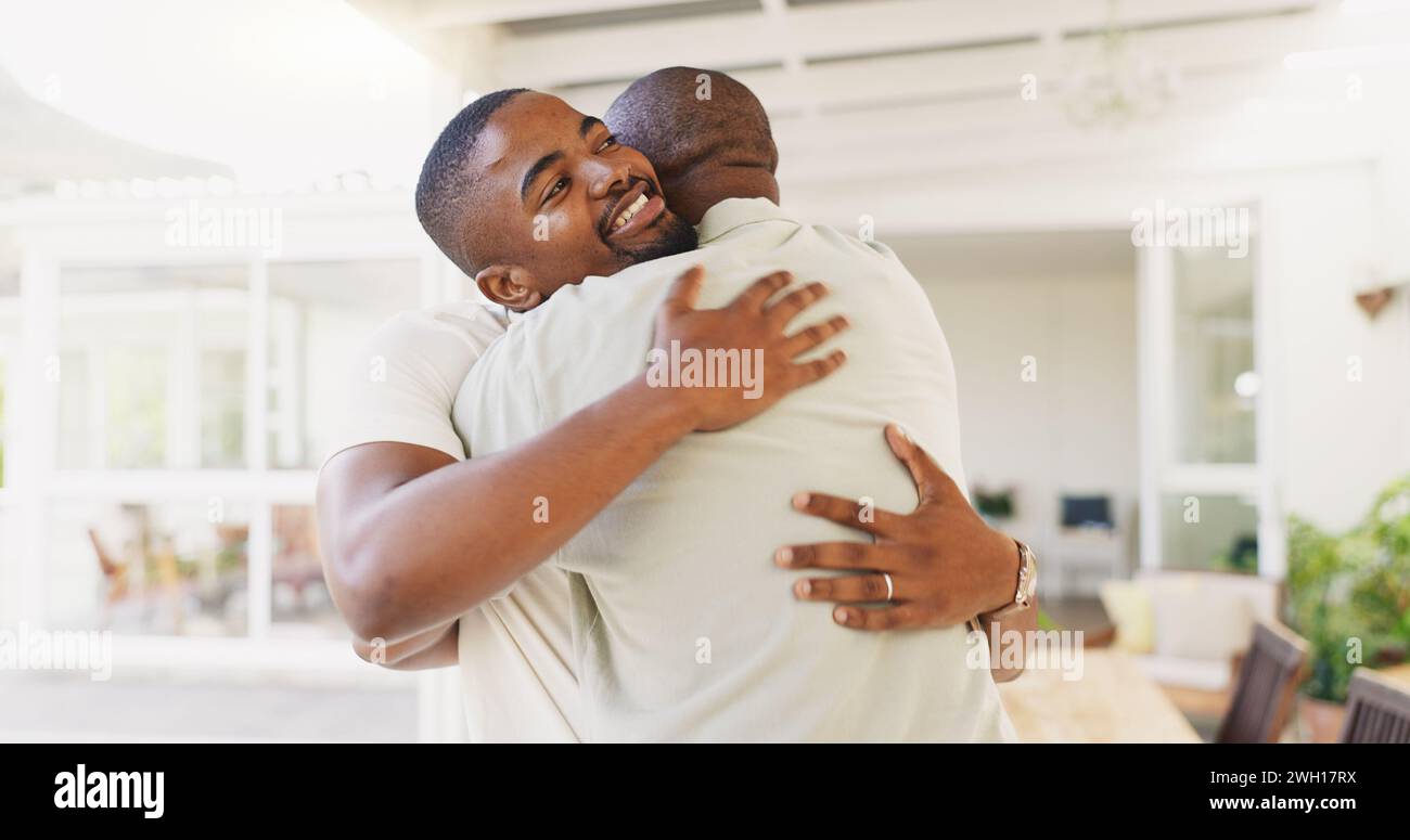 Senior African father, welcome and home with son, hug and love with ...