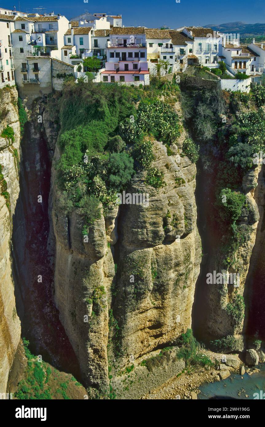 Houses in Ronda on cliff over Guadalevín River Gorge, view from Puente ...