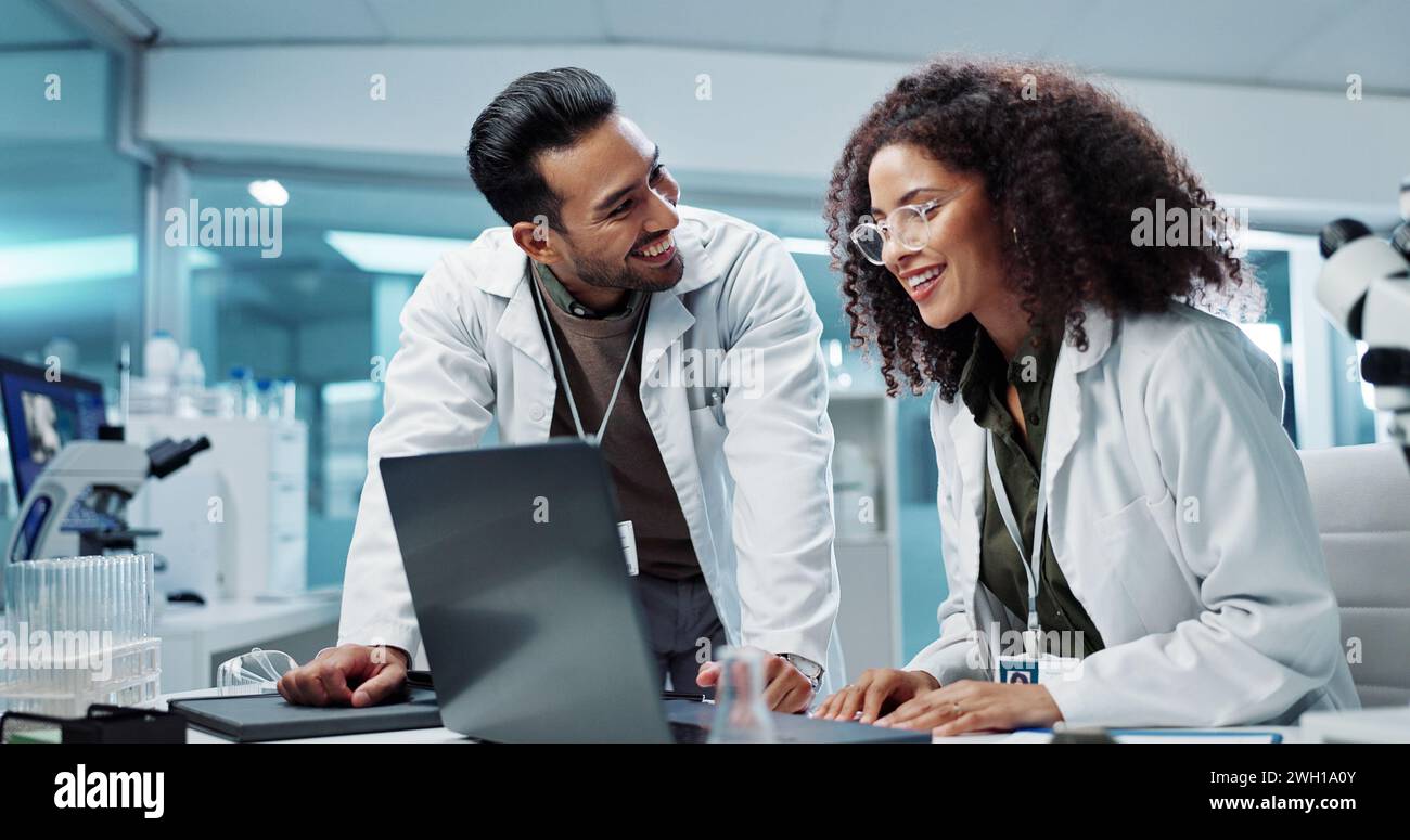 Scientist, teamwork and happy with laptop in laboratory for test ...