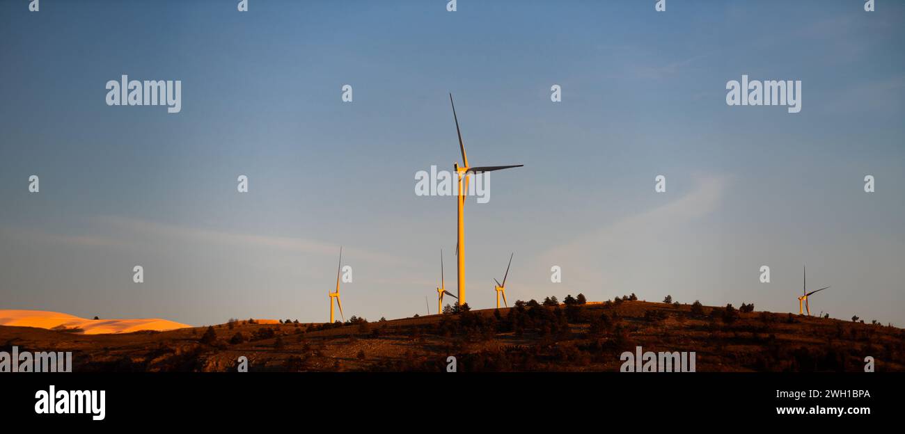: A striking vista of modern wind turbines, stationed amidst the ...