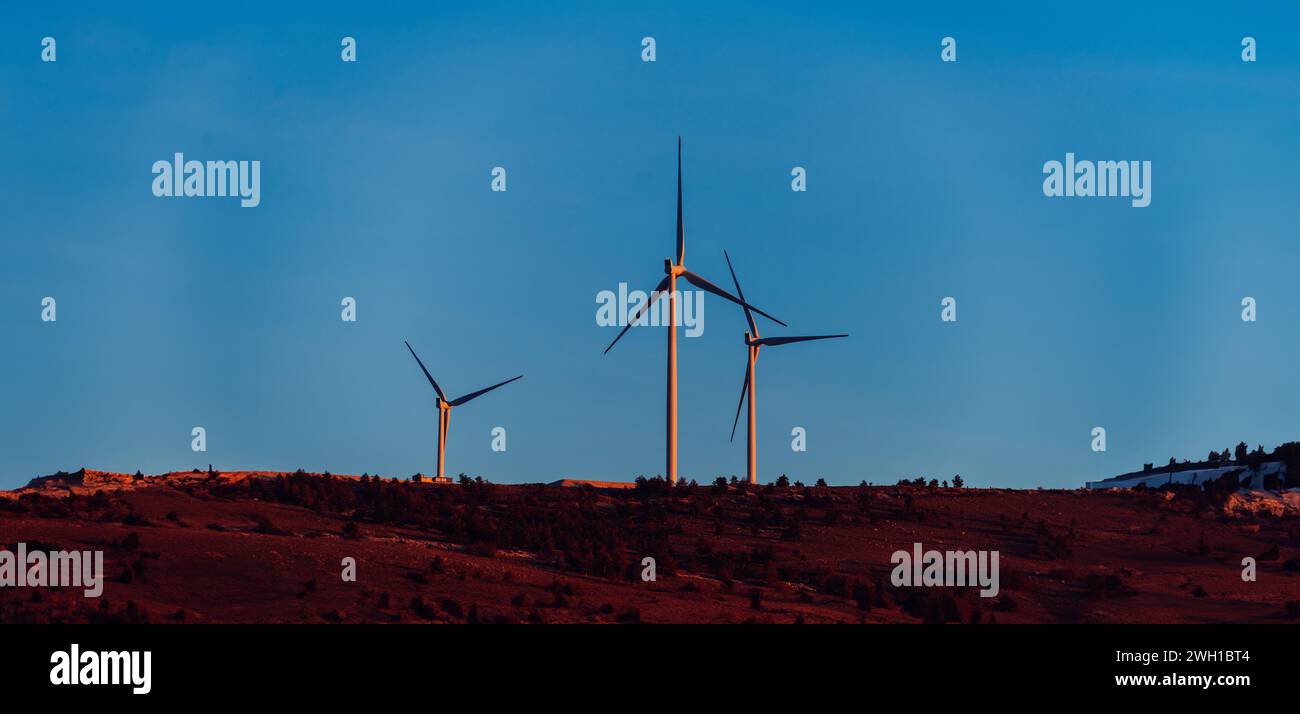 : A striking vista of modern wind turbines, stationed amidst the ...