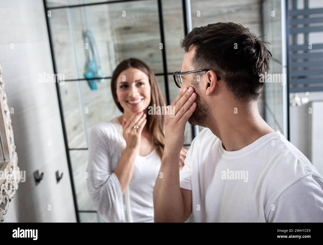 Couple going through morning routine in the bathroom Stock Photo - Alamy