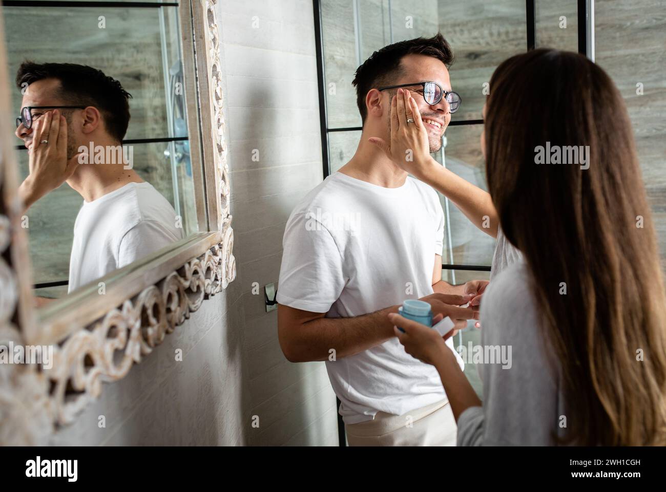 Couple going through morning routine in the bathroom Stock Photo - Alamy