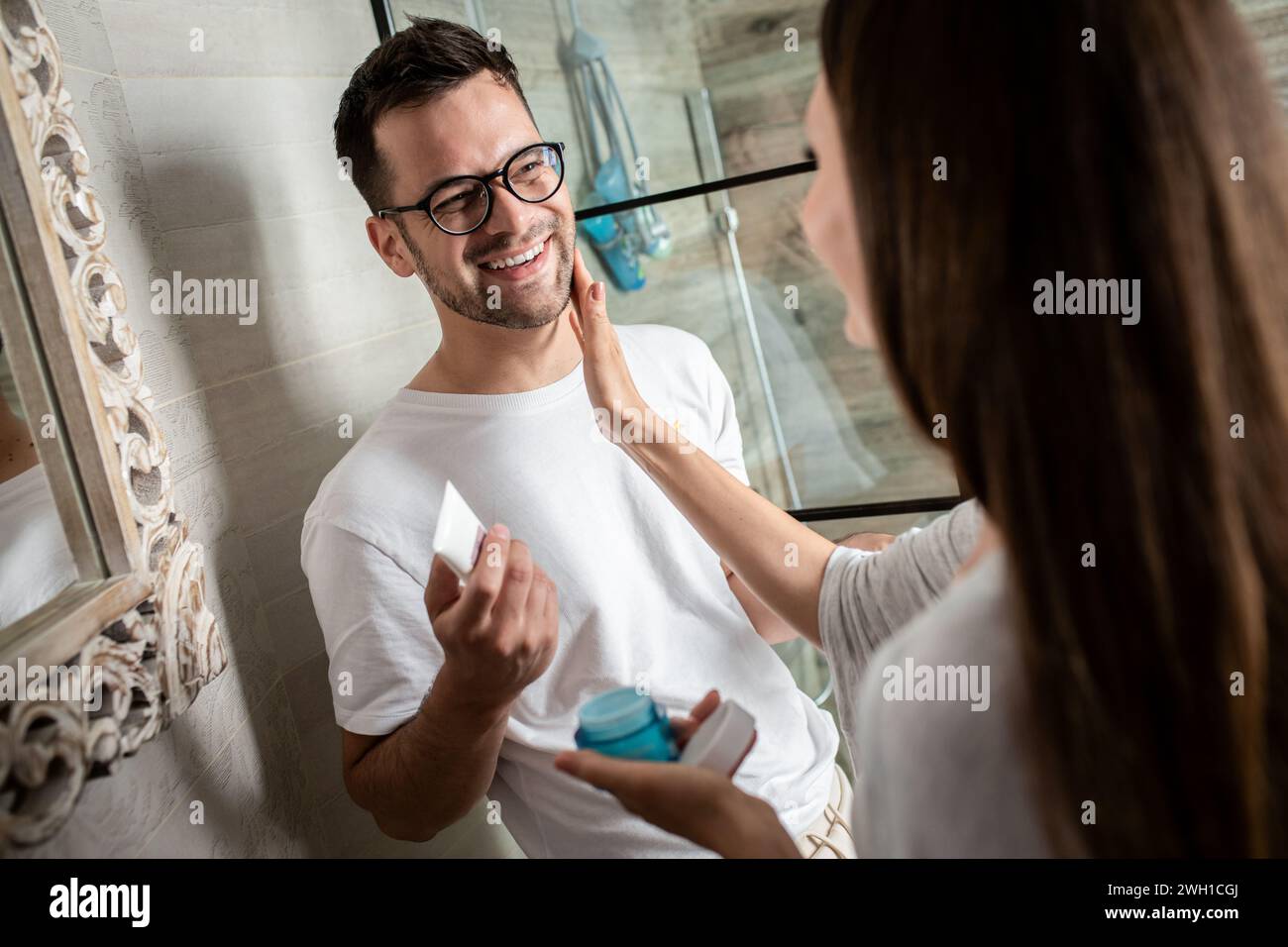 Couple going through morning routine in the bathroom Stock Photo - Alamy