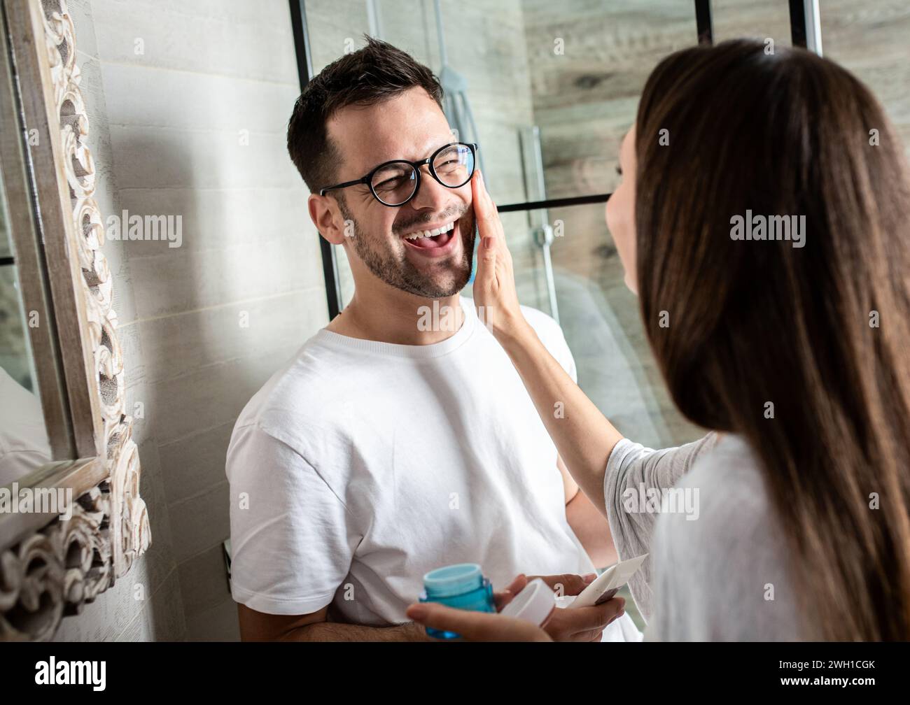 Couple going through morning routine in the bathroom Stock Photo - Alamy