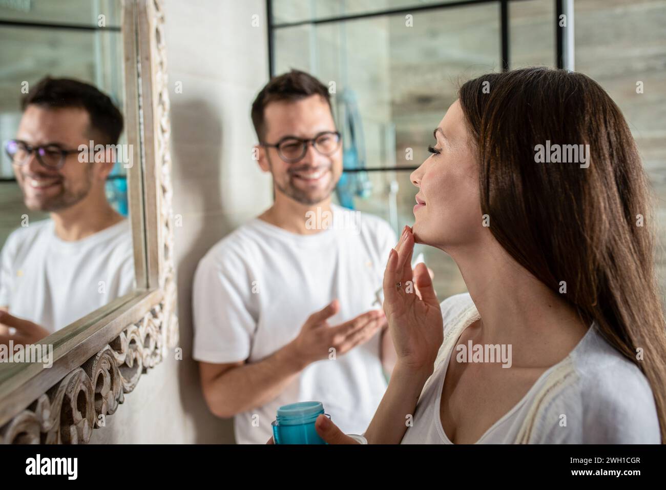 Couple going through morning routine in the bathroom Stock Photo - Alamy