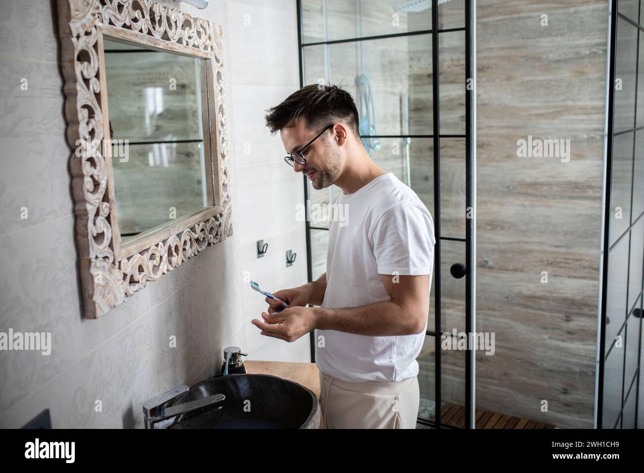 Man going through morning routine in the bathroom brushing teeth Stock ...