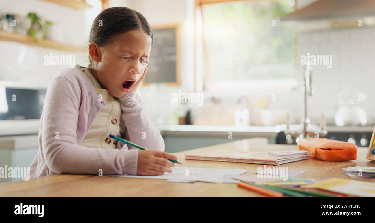 Tired, yawn and child with homework in kitchen, bored and doing project ...