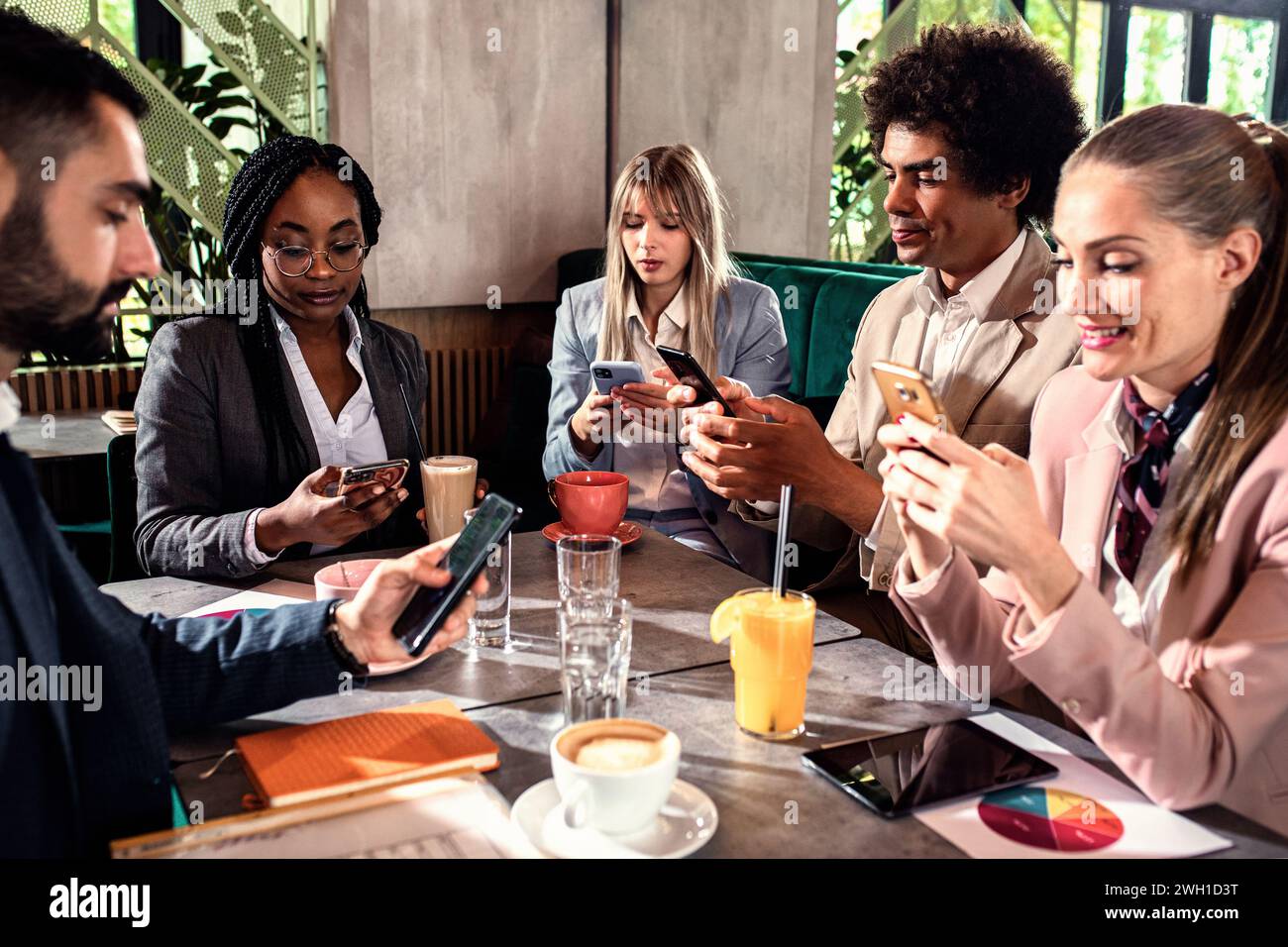 Group of business people having meeting in cafe Stock Photo - Alamy