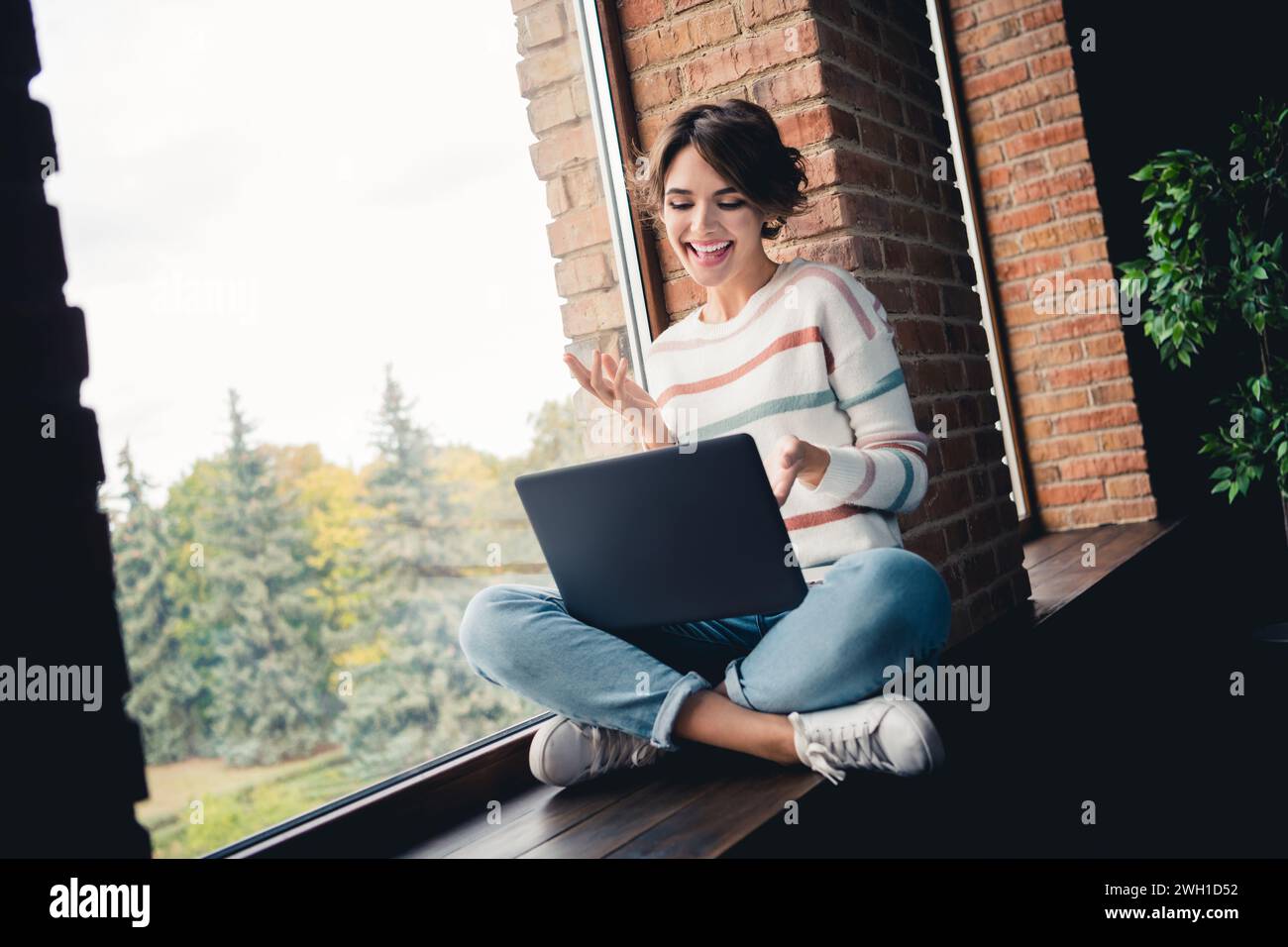 Full length portrait of positive nice person sit window sill speak ...