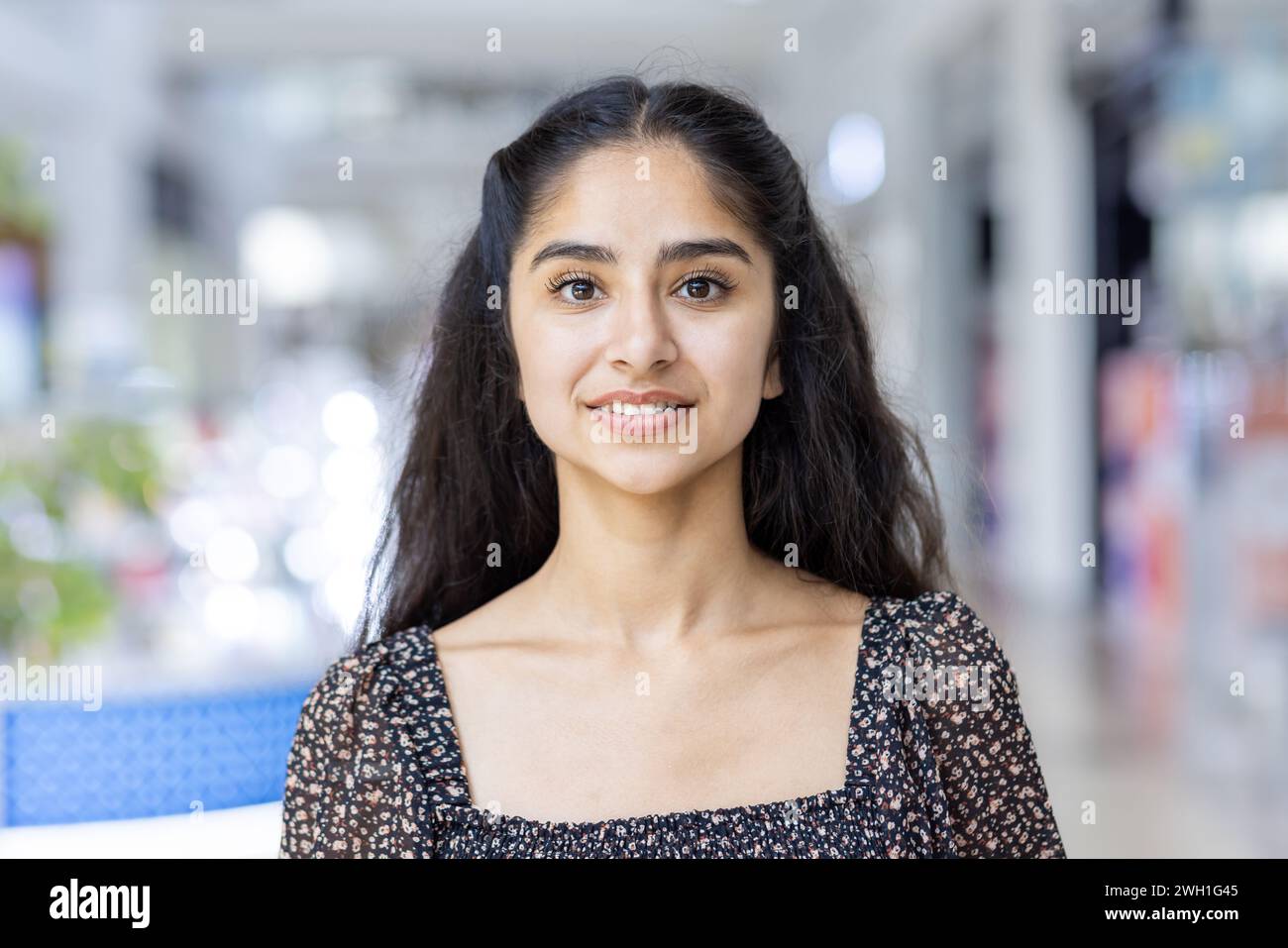 Happy Indian woman with a captivating smile, shopping in a mall ...