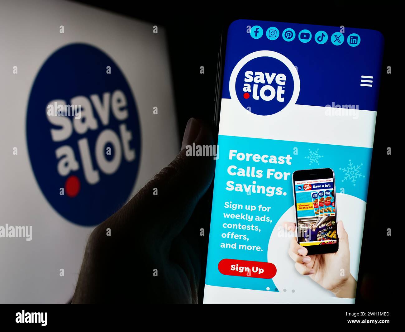 Person holding smartphone with webpage of US supermarket company Save A ...