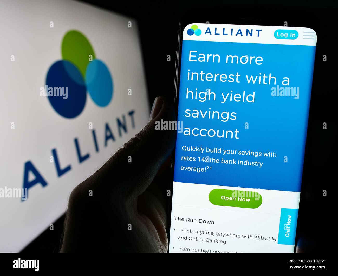 Person holding cellphone with webpage of US financial institution ...