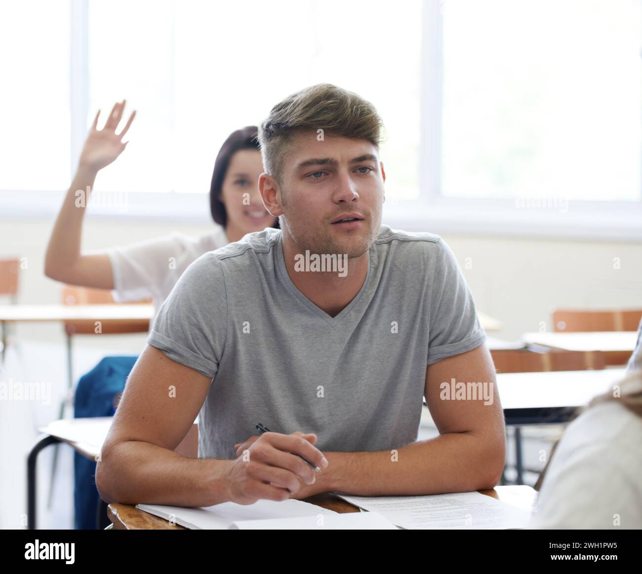 Man, learning and thinking in classroom at desk for education ...