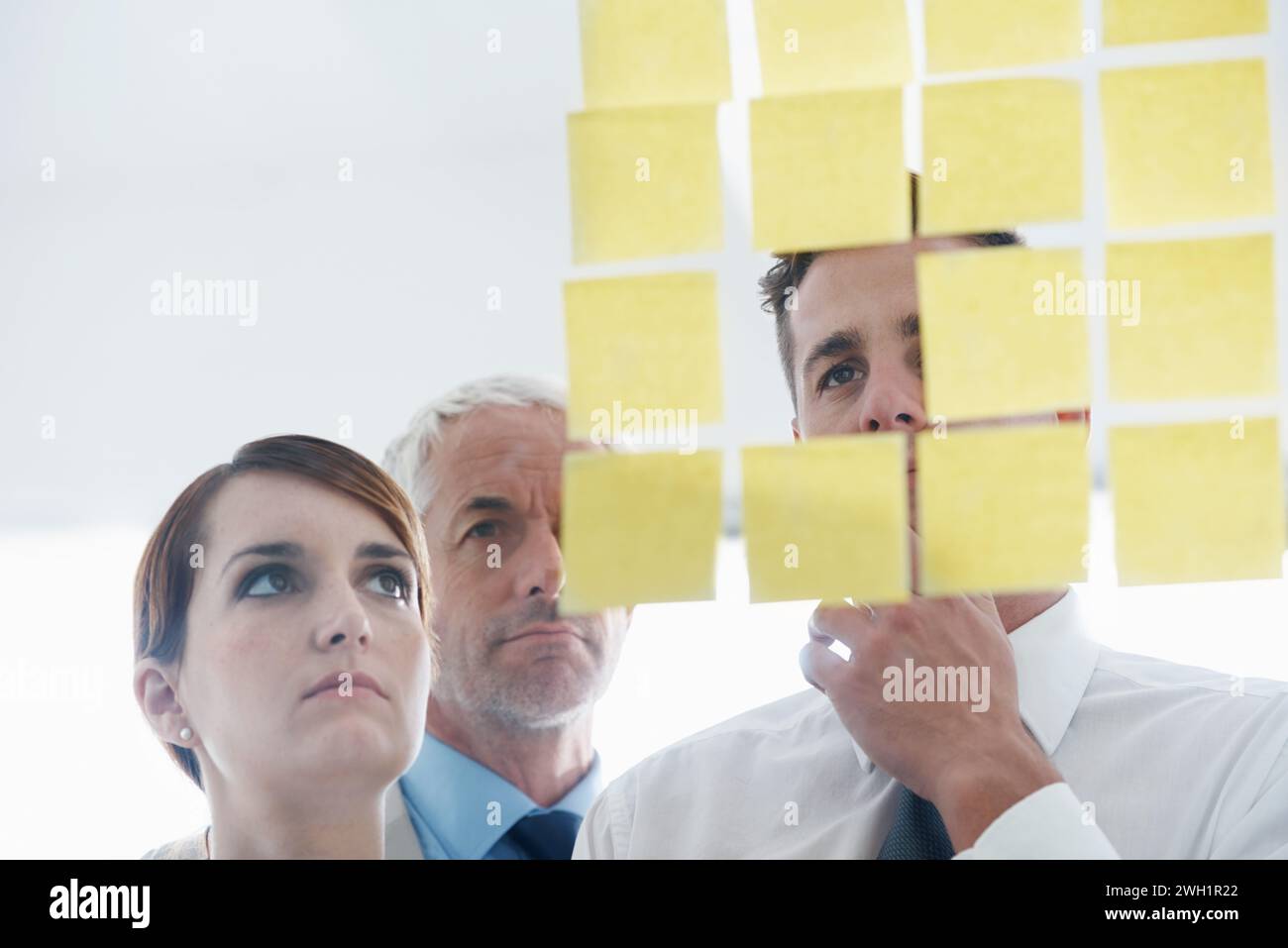 Team, sticky notes and glass wall for planning, thinking and vision for ...