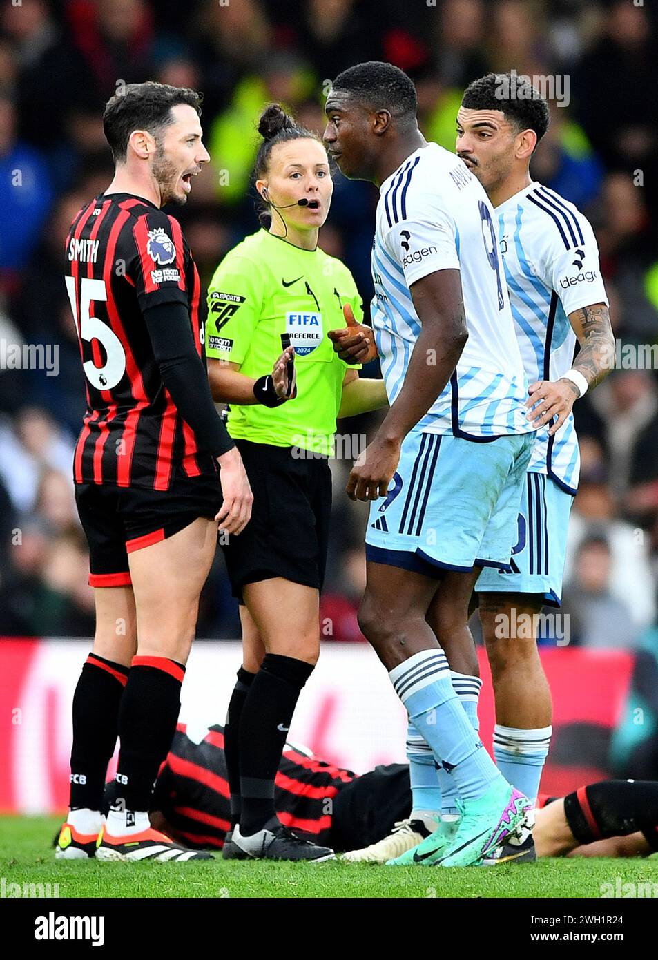 Referee Rebecca Welch stands between Adam Smith of AFC Bournemouth and ...