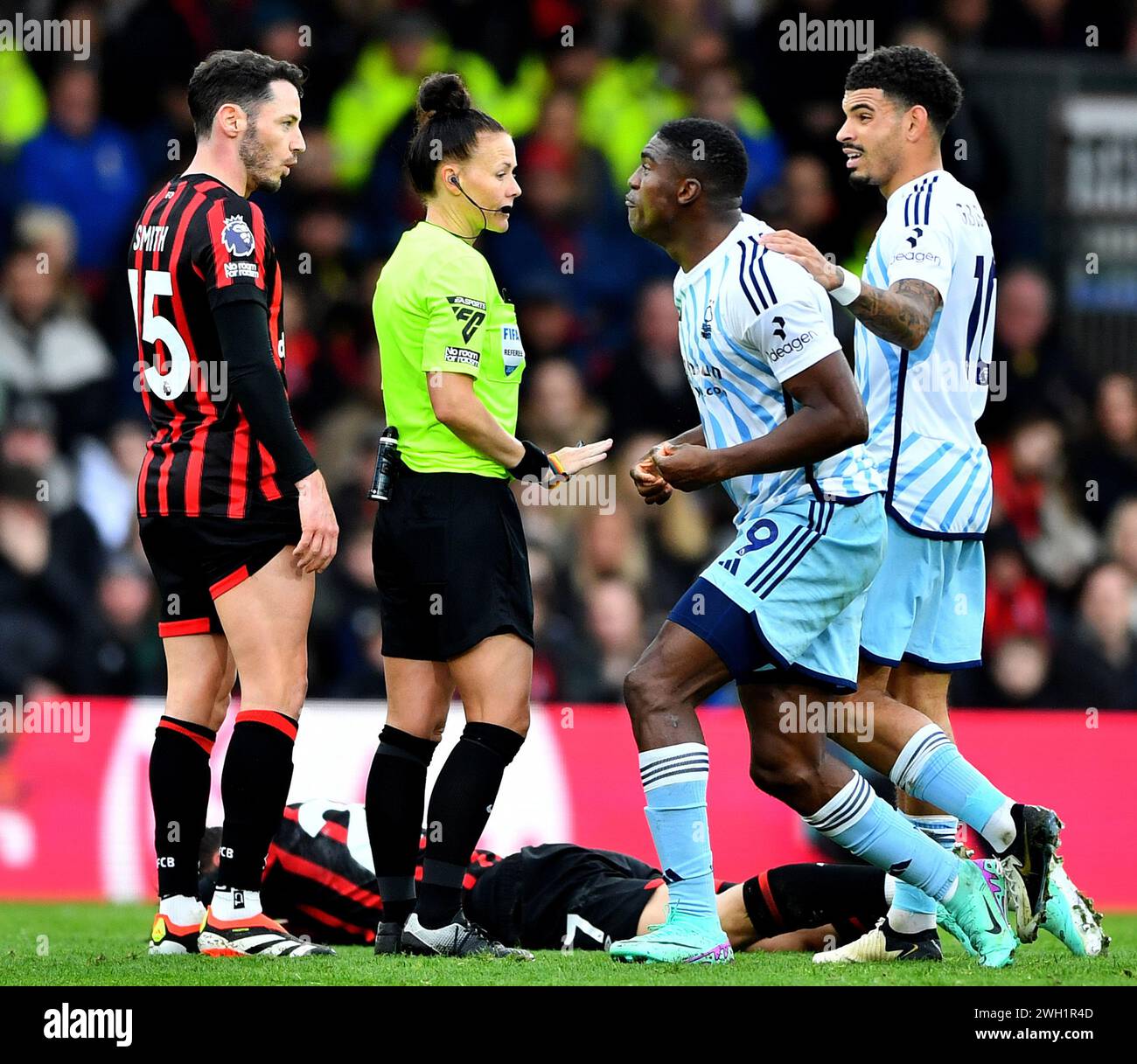 Referee Rebecca Welch stands between Adam Smith of AFC Bournemouth and ...