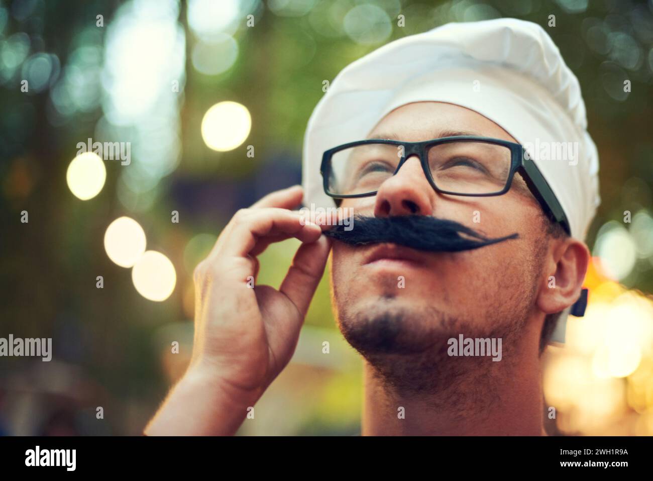 Man, fake mustache and beret at concert with thinking in nature ...
