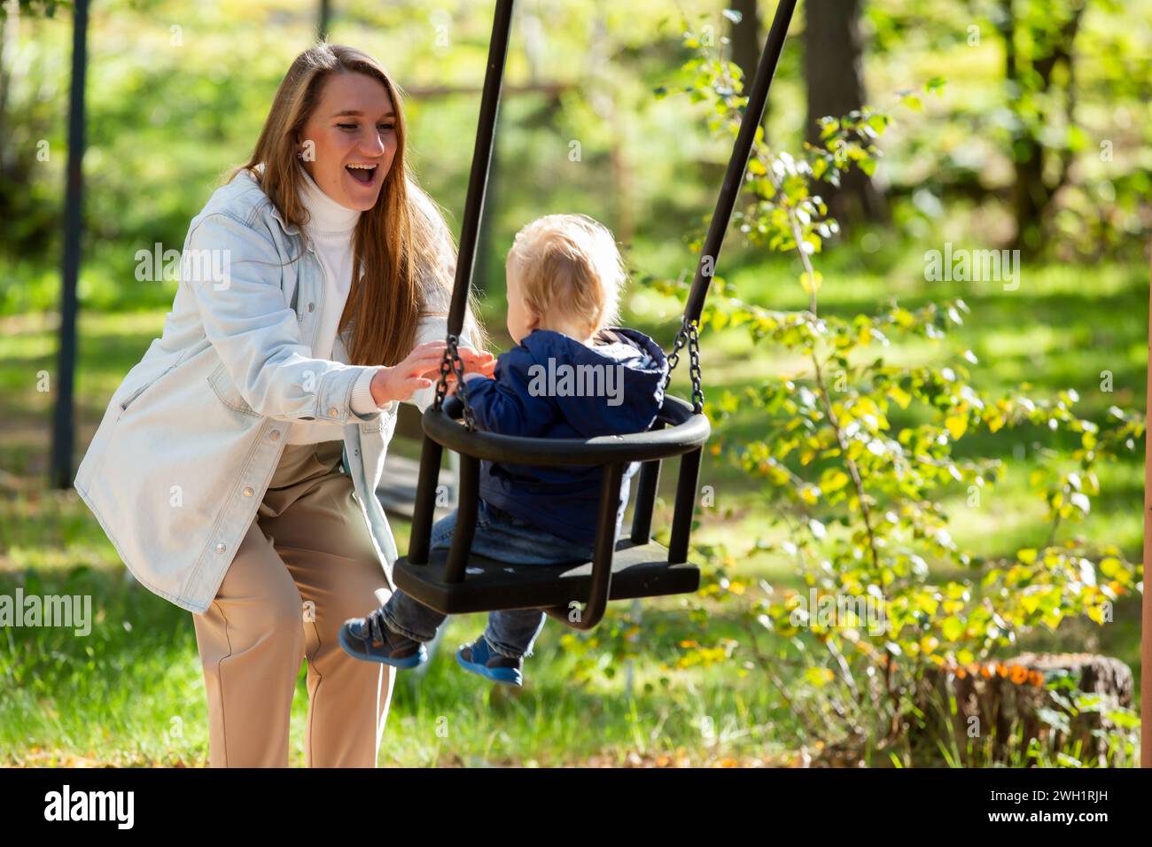 The mother with two children is having a fun time at the playground ...