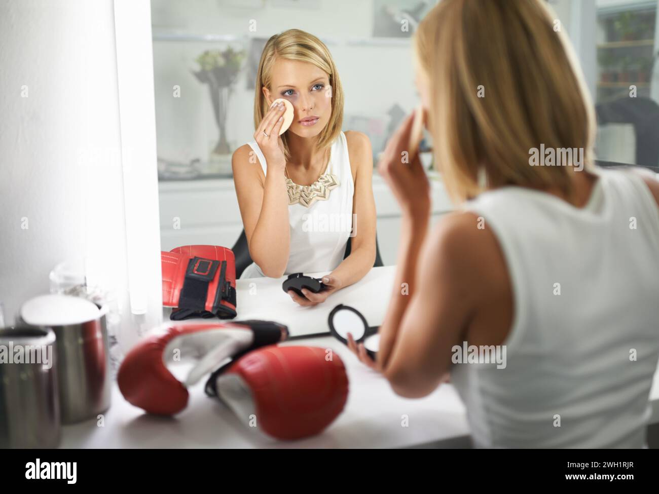 Woman, bruise and boxing gloves by mirror, makeup and stylish outfit in ...