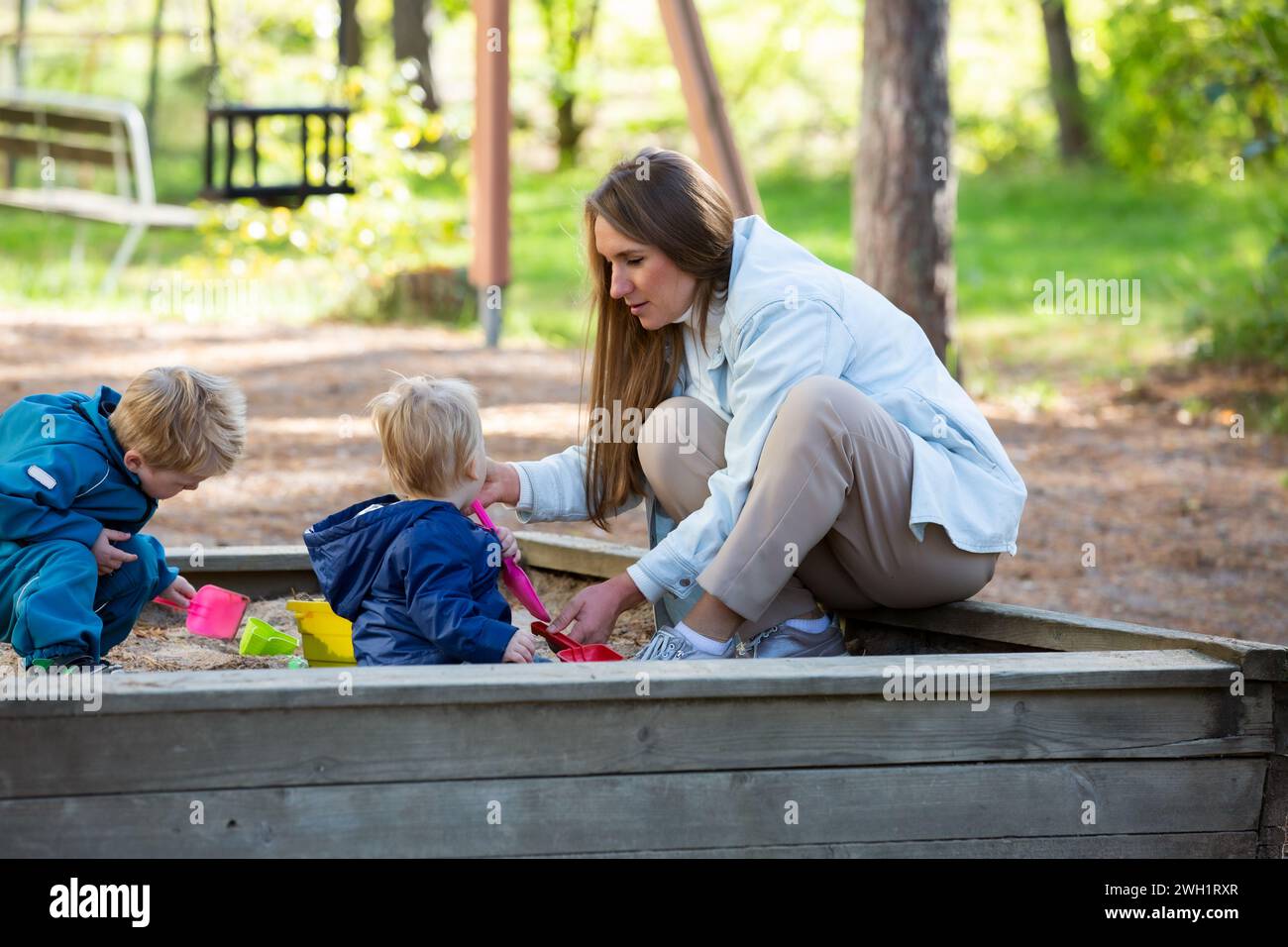 The mother with two children is having a fun time at the playground ...