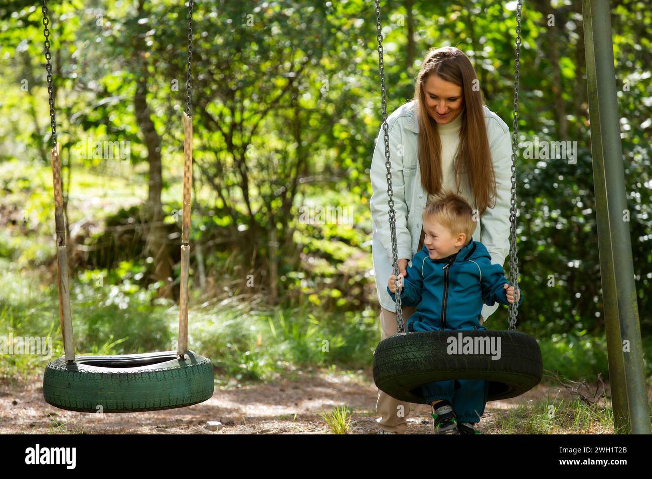 The mother with her child is having a fun time at the playground. The ...