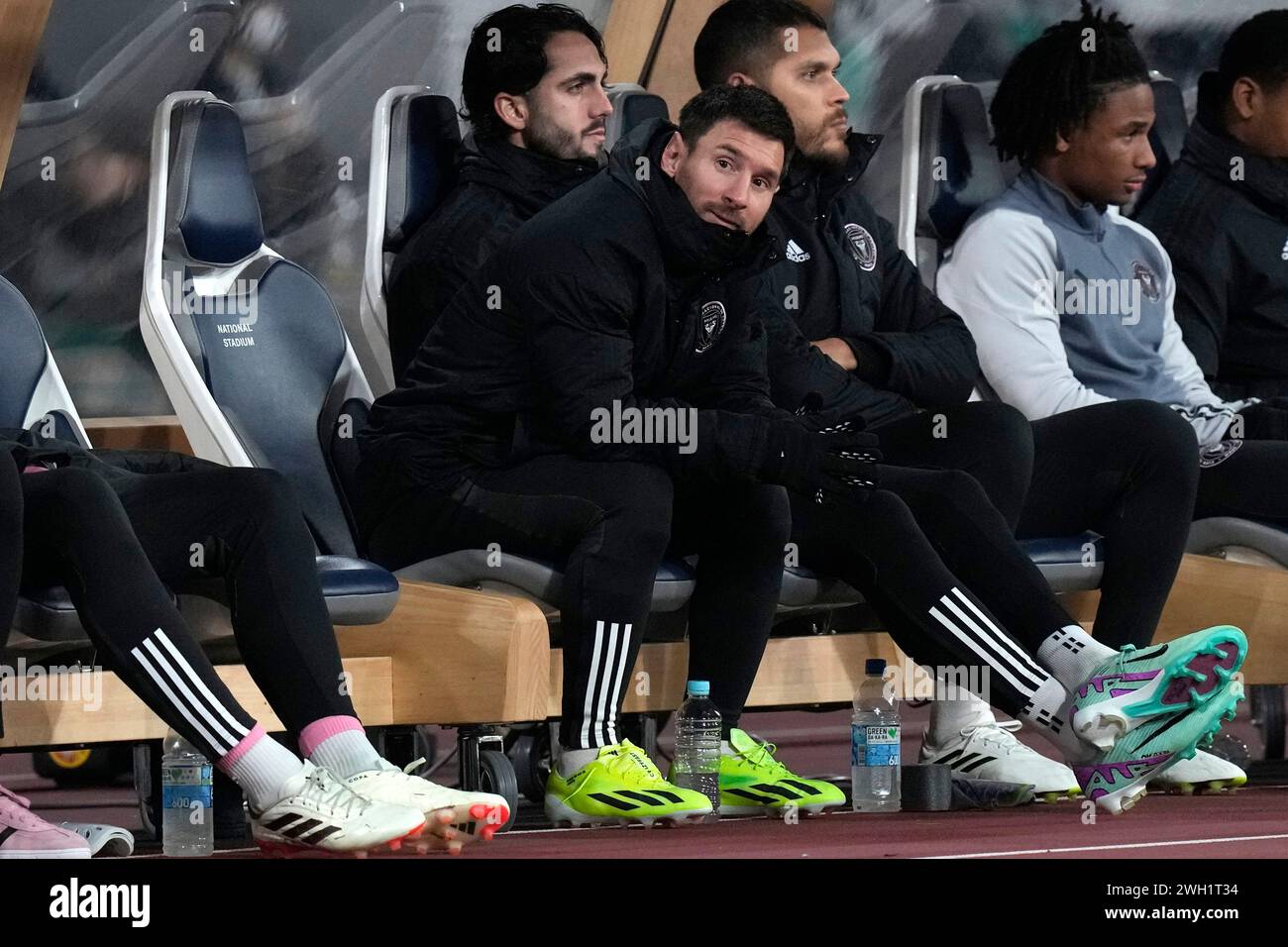 Inter Miami's Lionel Messi, center, sits on the bench during the ...