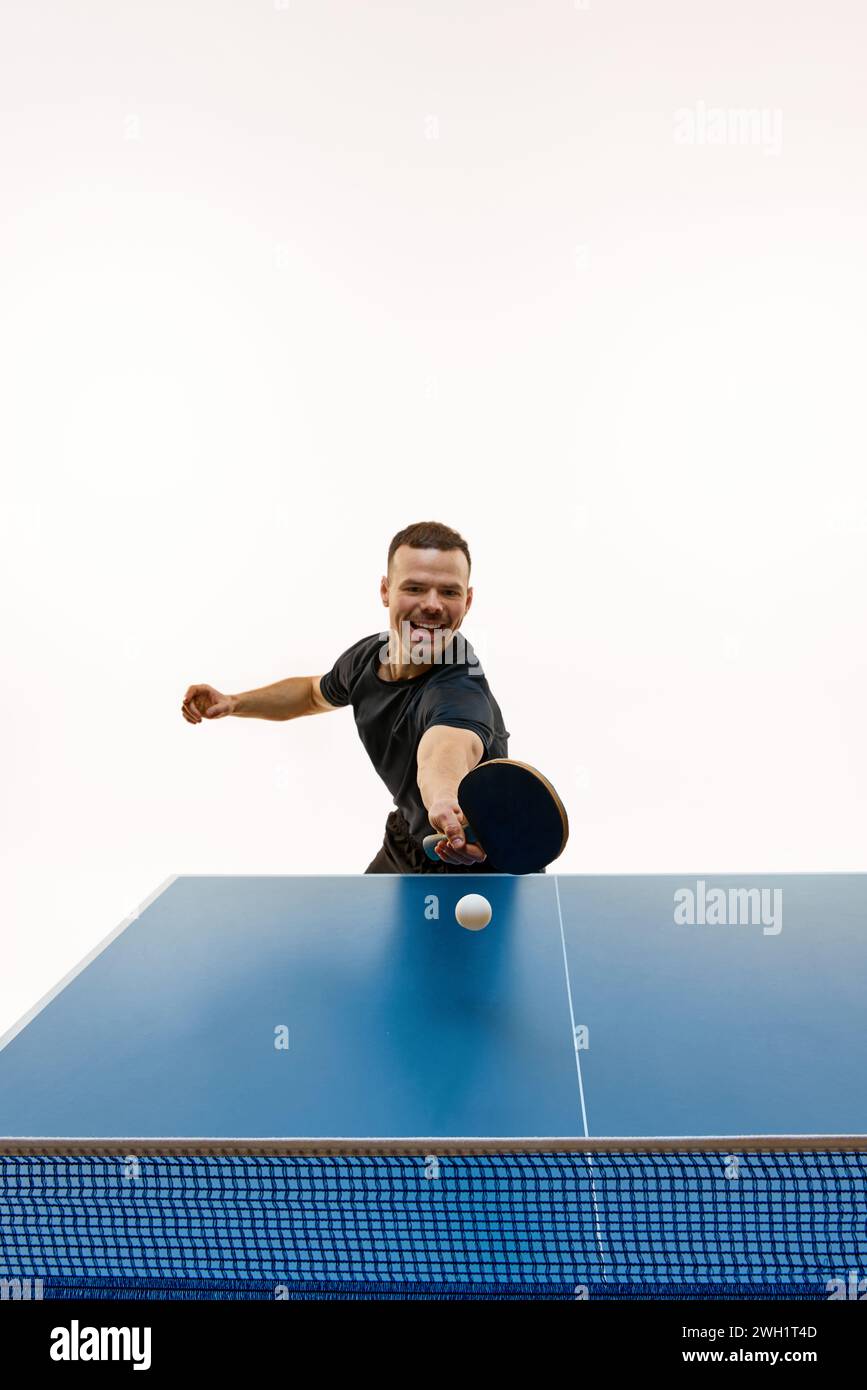 Competitive and positive young man, table tennis player with ...
