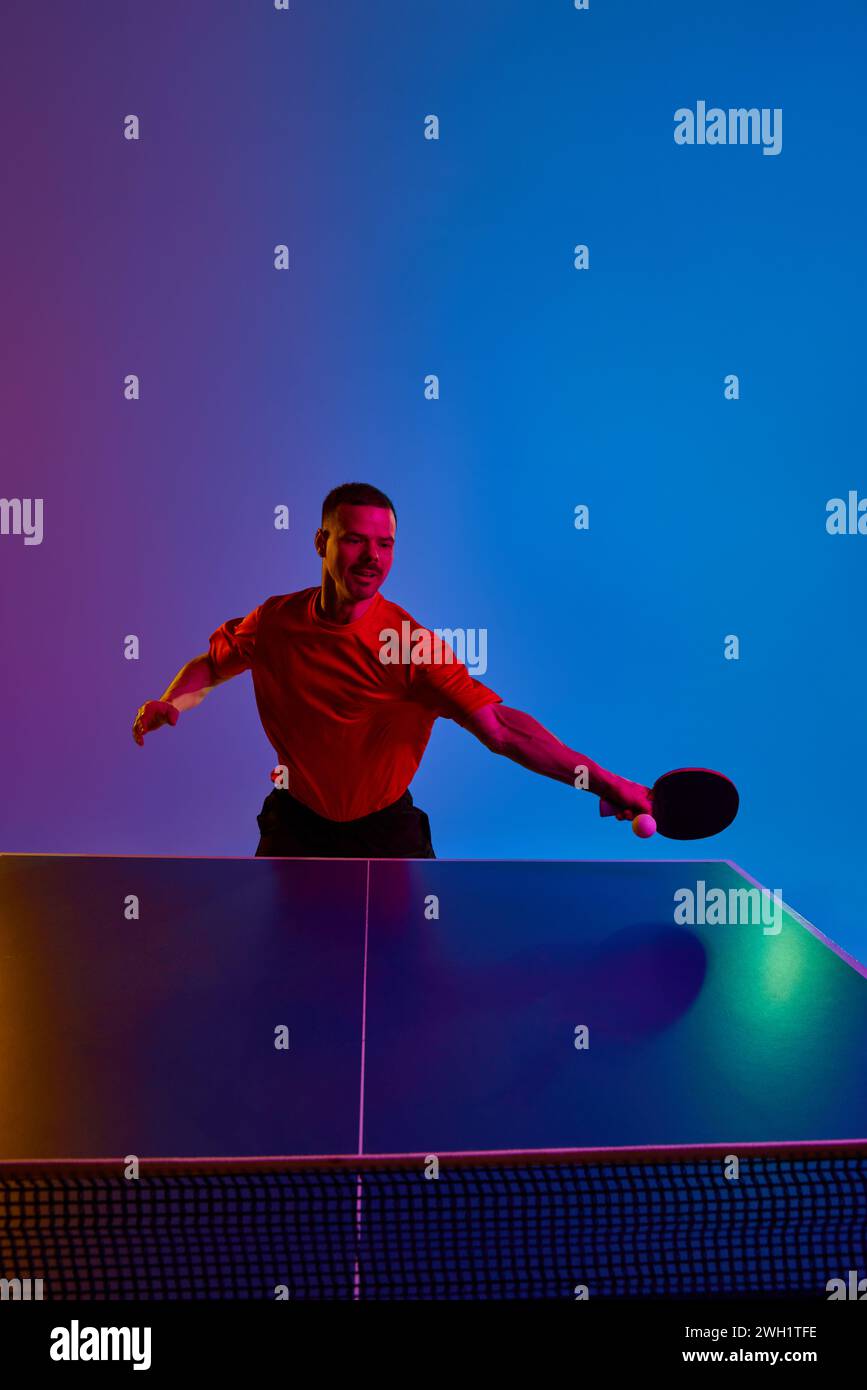 Portrait of athletic concentrated man training hits ball, attack ...