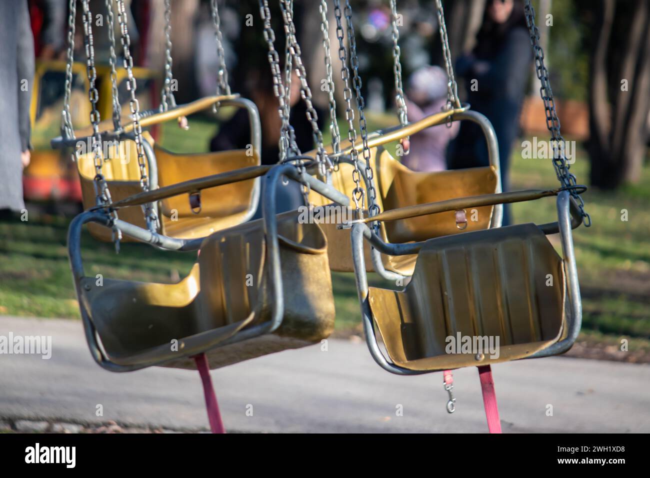 Empty carousel metal seat at the amusement park concept in a city park ...