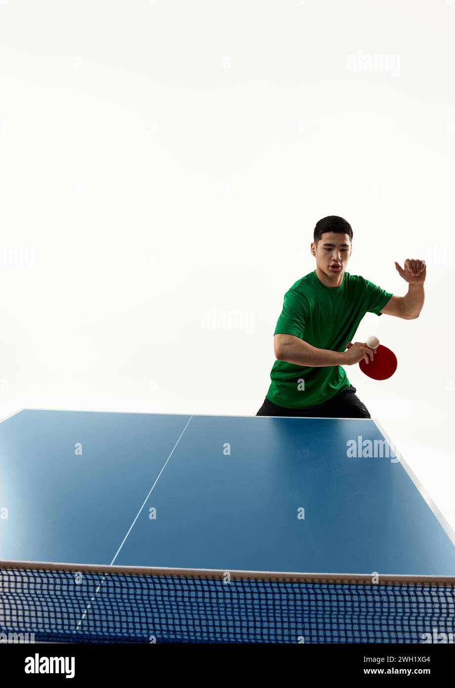 Fit Asian man, table tennis player in green sport uniform focused on ...