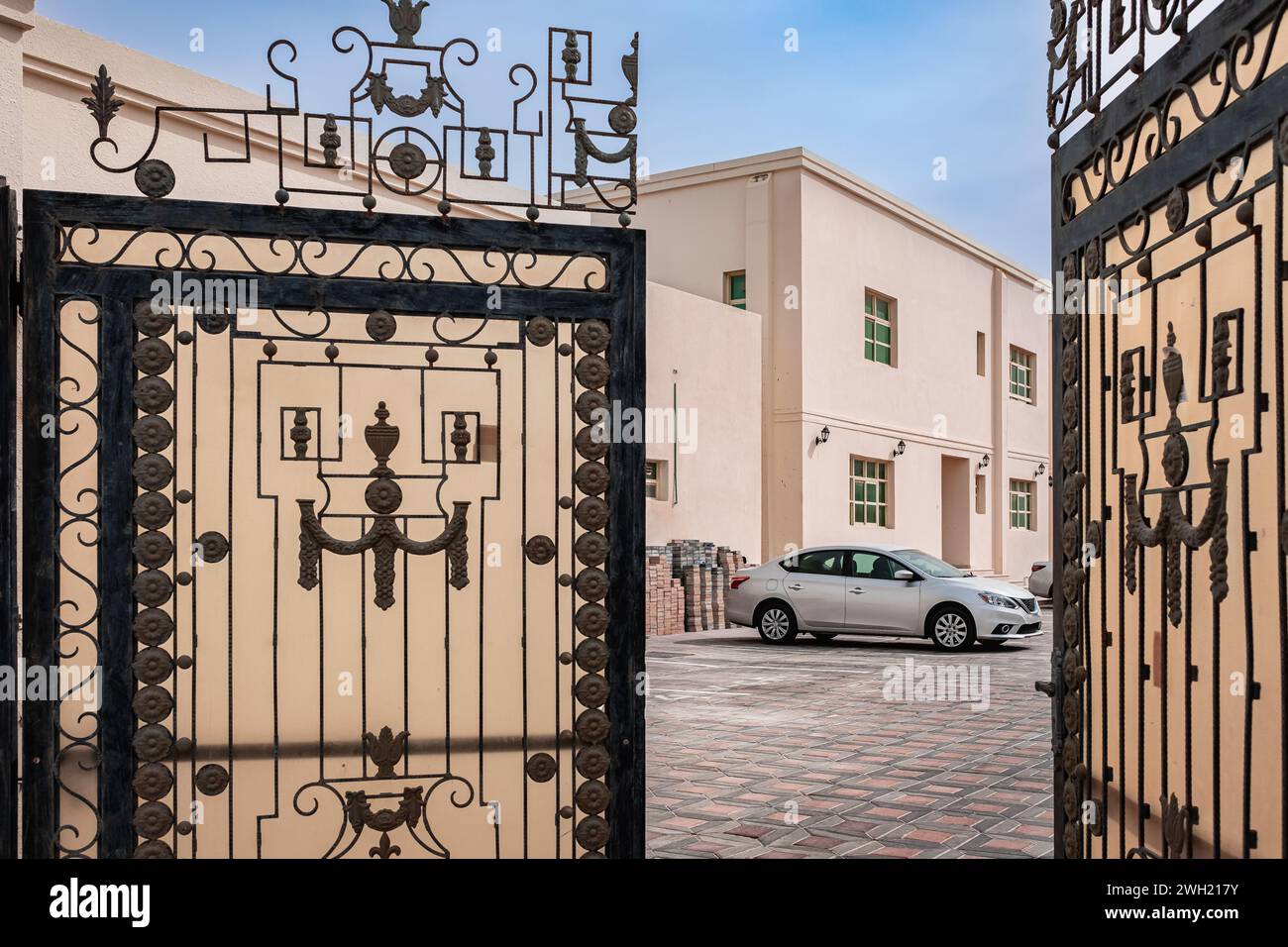 Open large double metal gate. Double wrought-iron gate. Wrought iron ...