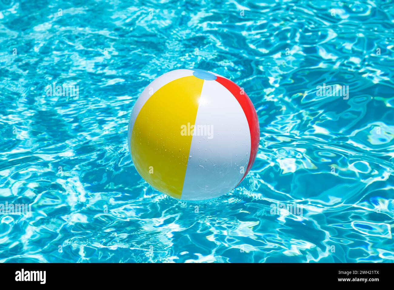 Summer swimming pool. Beach ball in swimming pool. Summer vacation ...