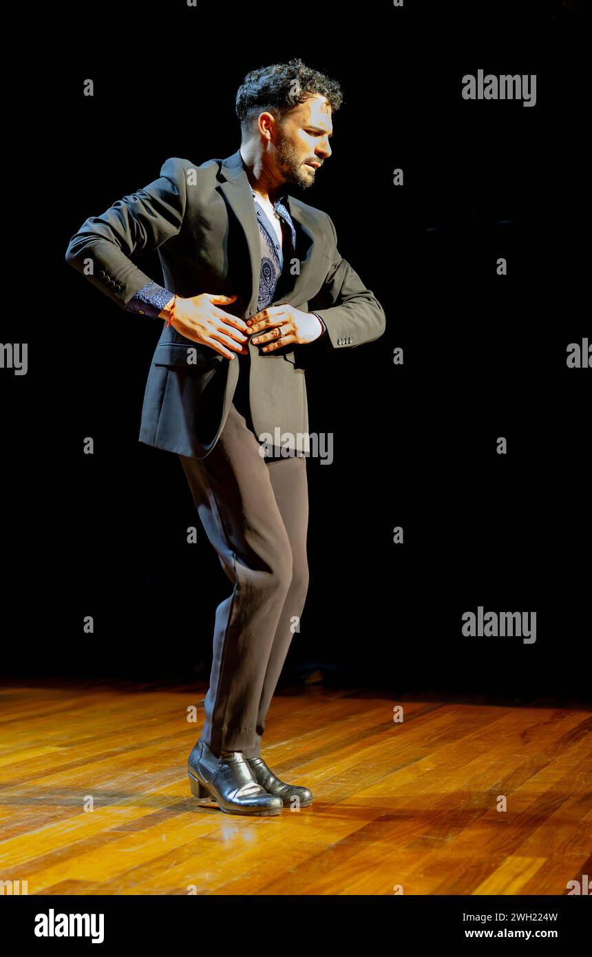 "Male flamenco dancer with intense expression performing on a wooden ...
