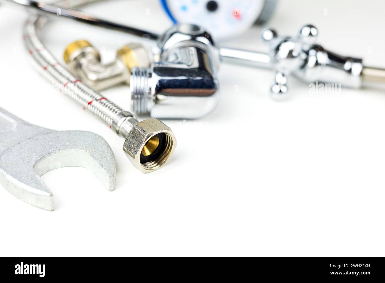 Plumbing parts, accessories and tools on a white background with copy ...