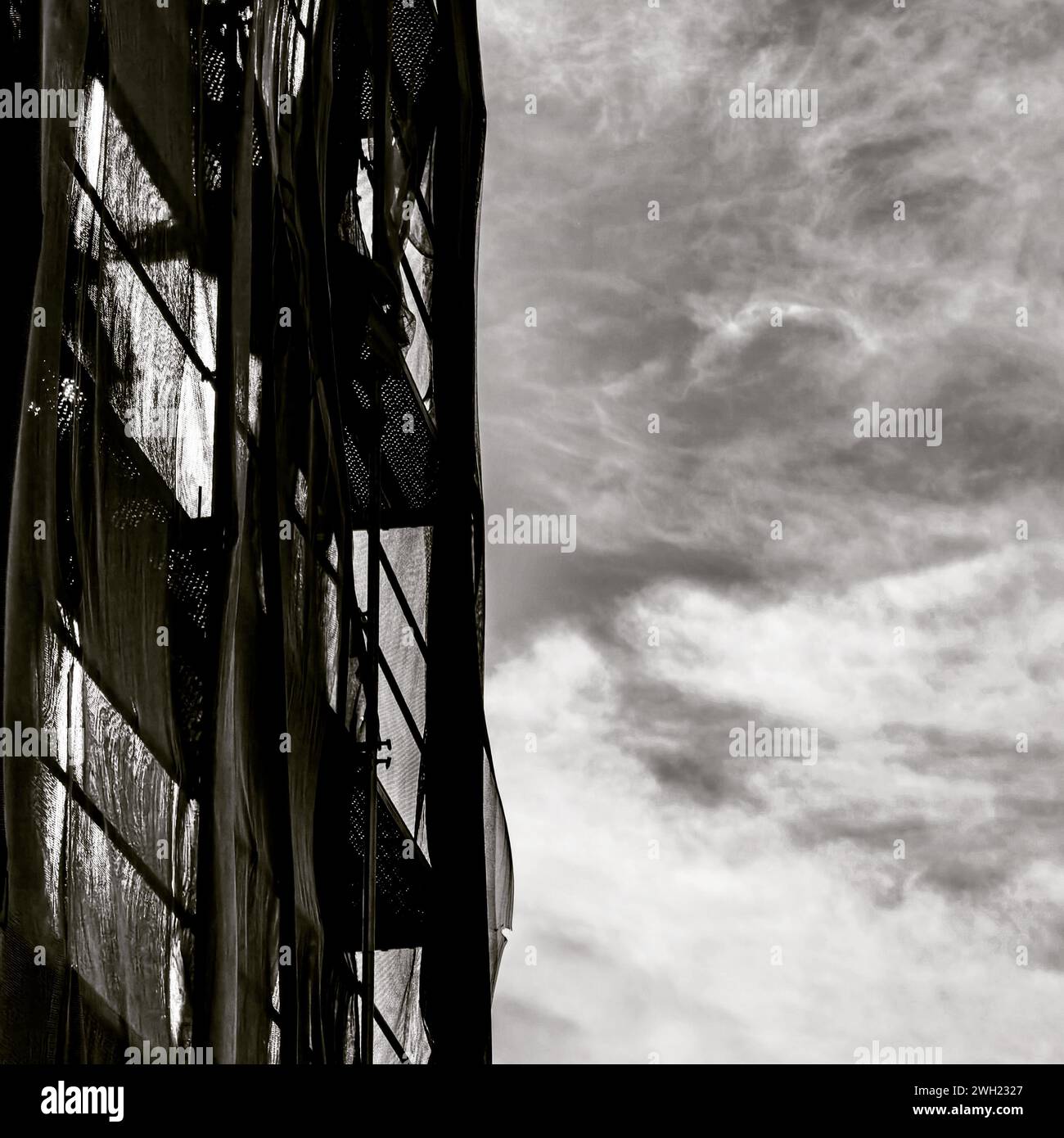 Building under construction, illuminated scaffolding windows by the sun ...